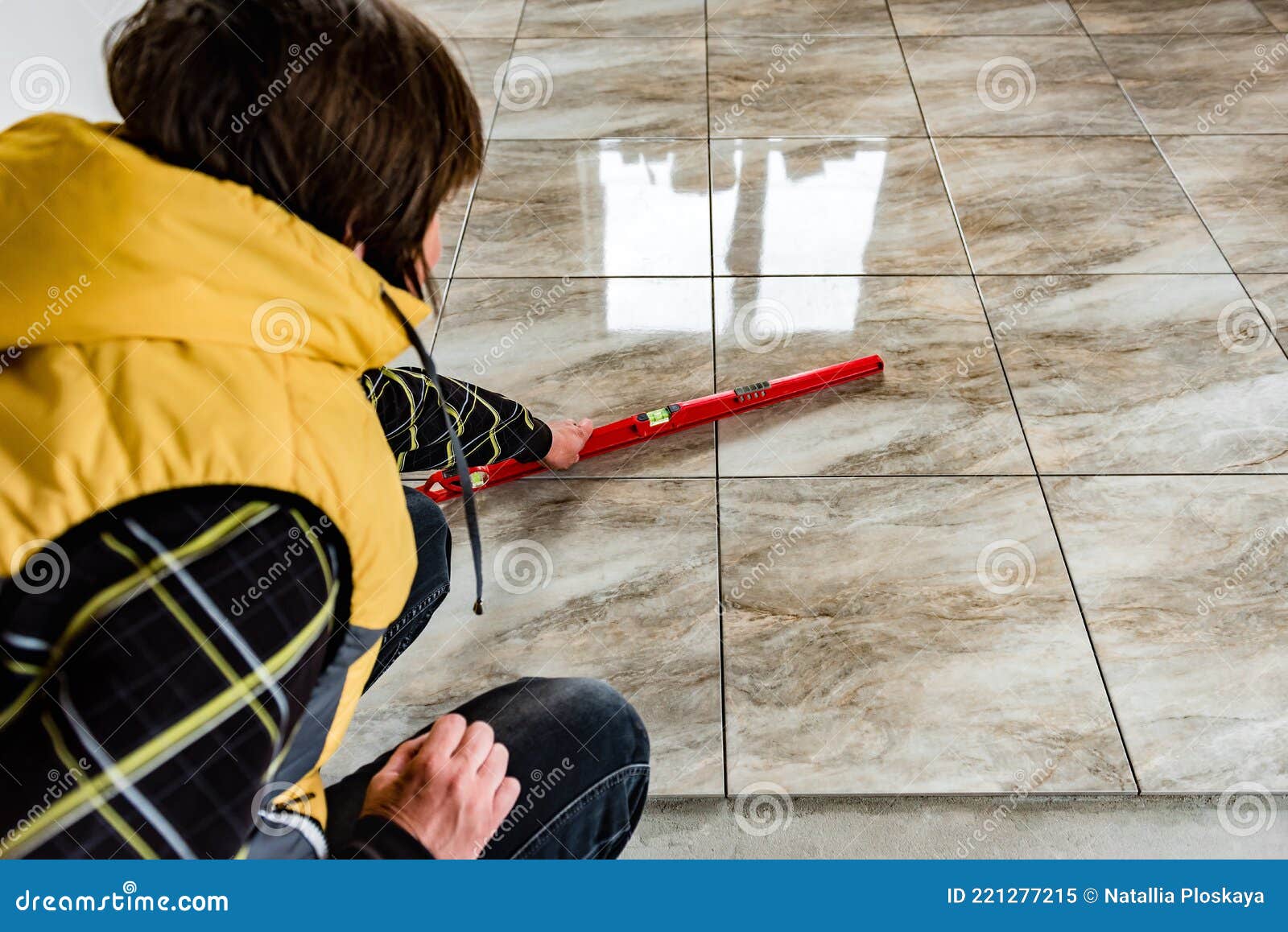 Worker Checks the Level of the Tile Floor. Stock Image - Image of ...