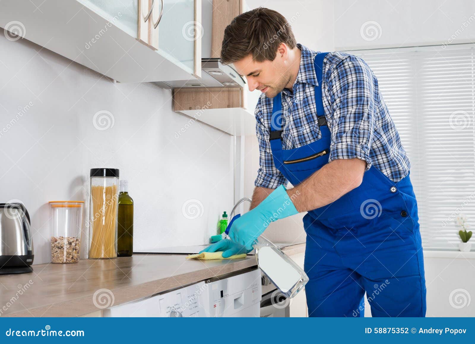 Worker Cleaning Countertop with Rag Stock Photo - Image of glove ...