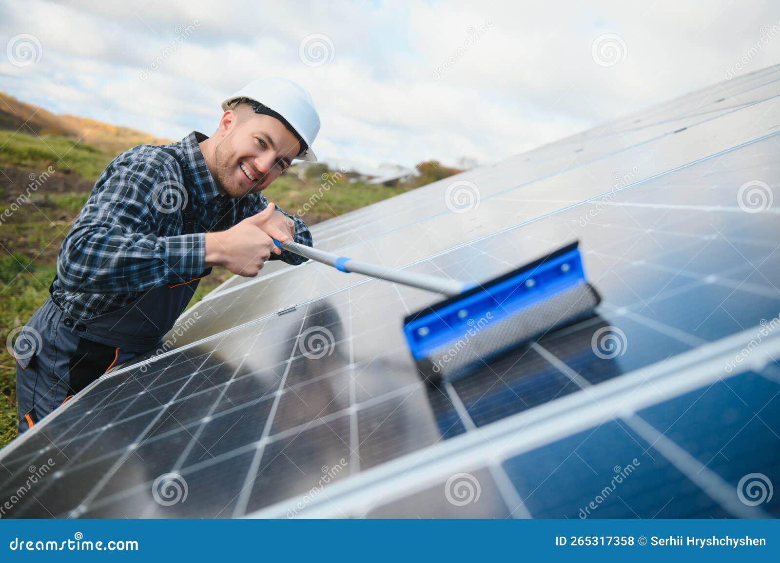 A Worker Cleaning Dust and Dirt Form Solar Panels. Stock Photo - Image ...