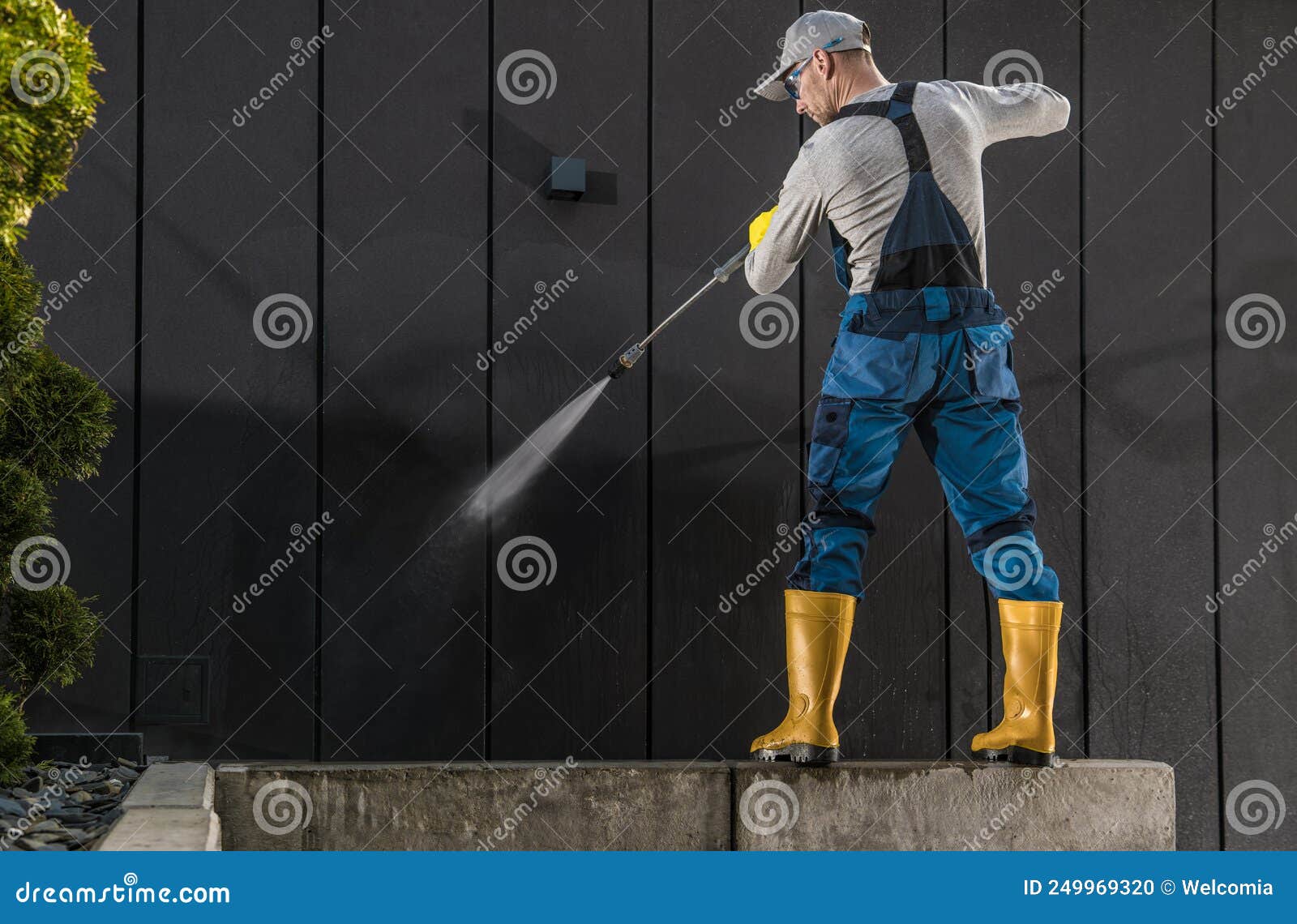 Worker Cleaning Modern Building Dark Wall Using Pressure Washer Stock ...