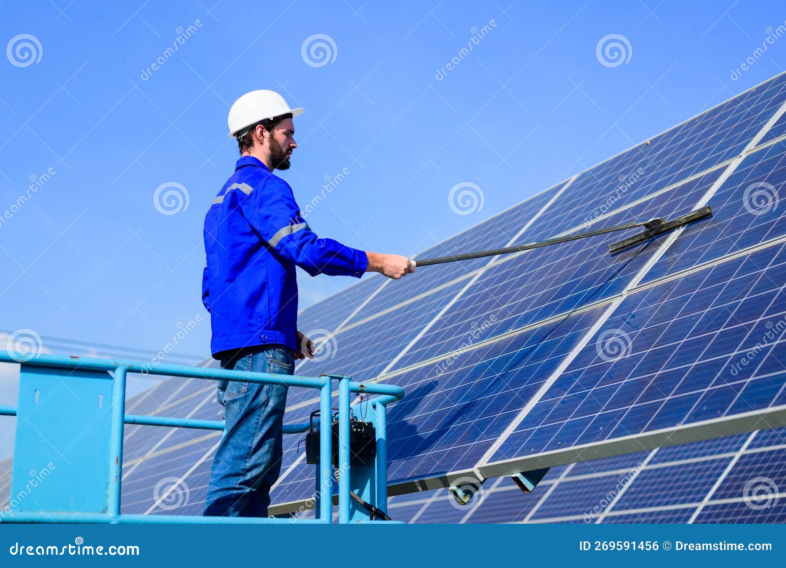 Worker Cleaning Solar Panel at Solar Cell Farm Stock Photo - Image of ...