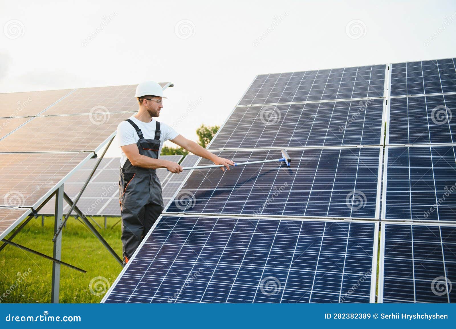 Worker Cleaning Solar Panels after Installation Outdoors. Stock Image ...