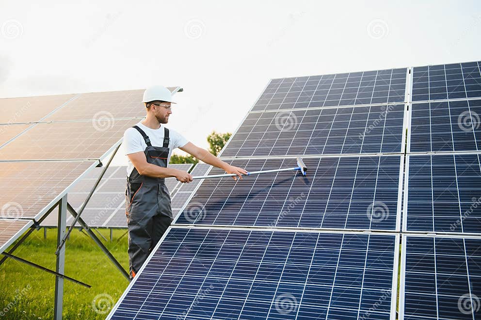 Worker Cleaning Solar Panels after Installation Outdoors. Stock Image ...