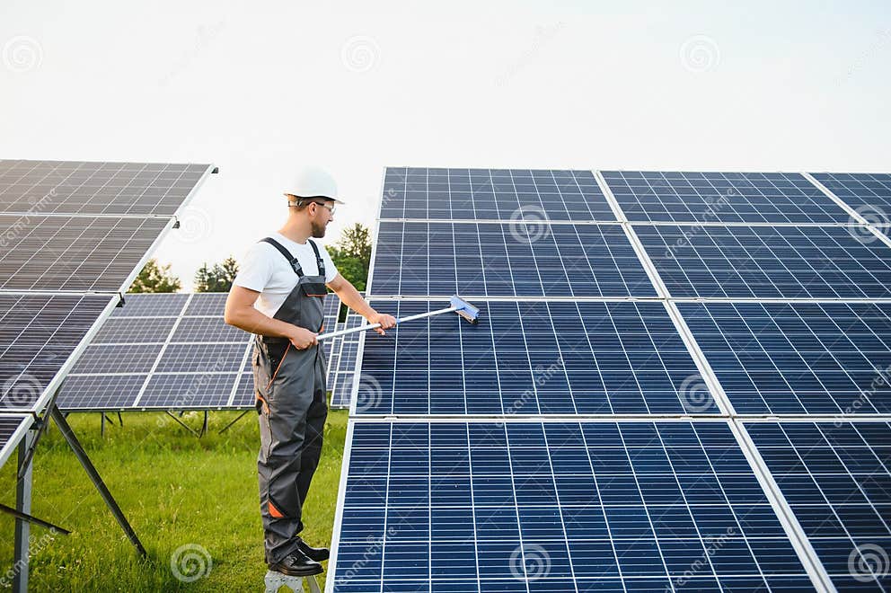 Worker Cleaning Solar Panels after Installation Outdoors. Stock Image ...
