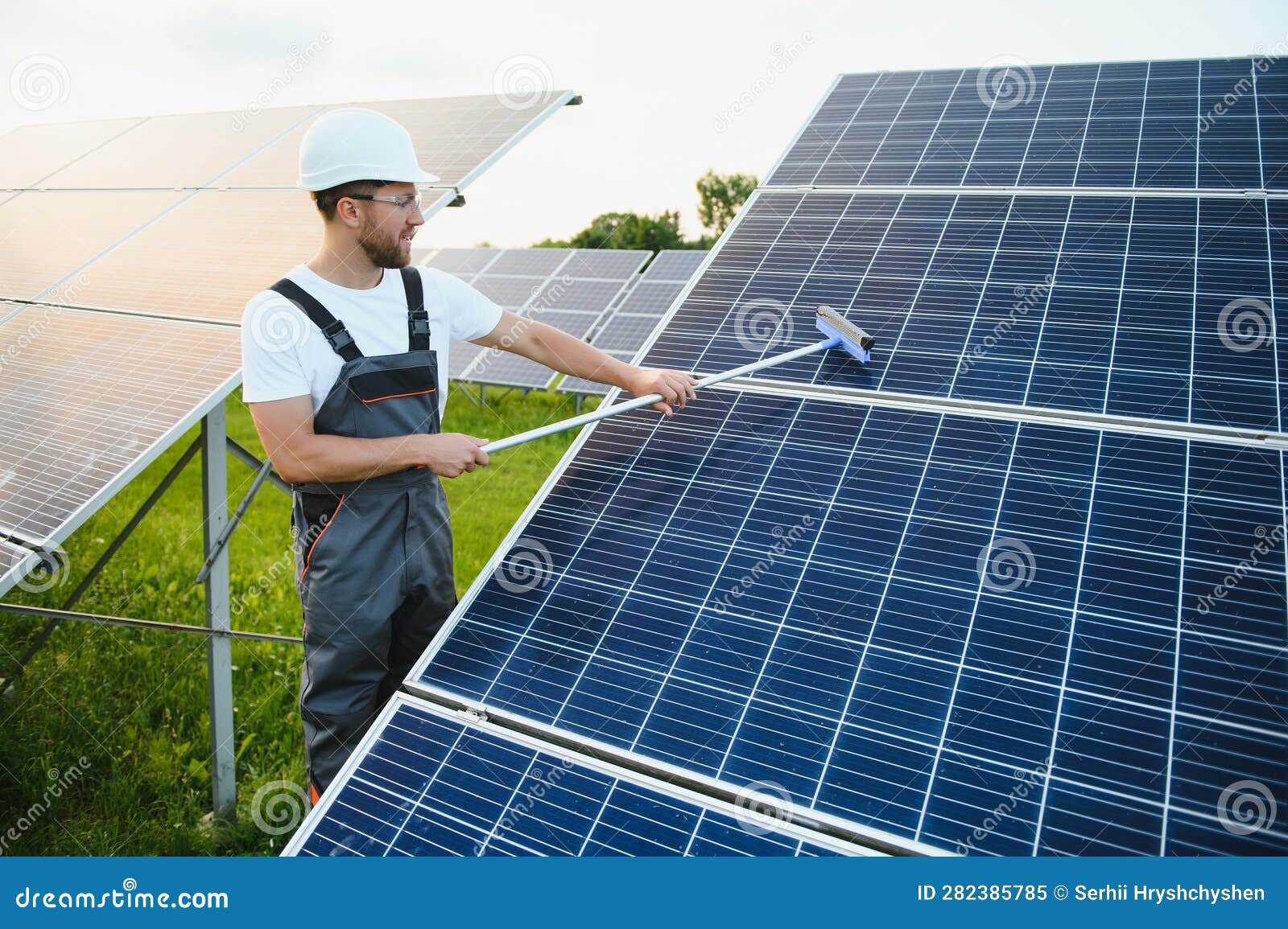 Worker Cleaning Solar Panels after Installation Outdoors. Stock Image ...