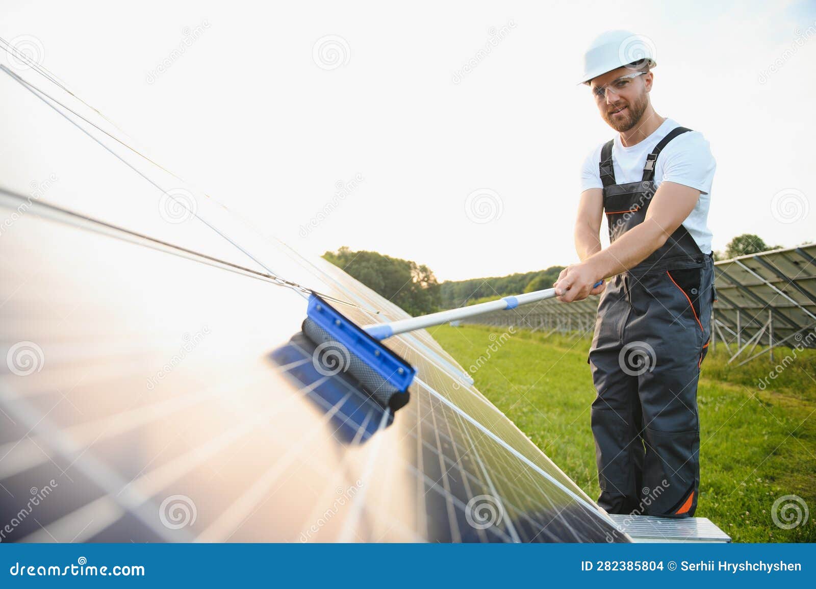 Worker Cleaning Solar Panels after Installation Outdoors. Stock Photo ...