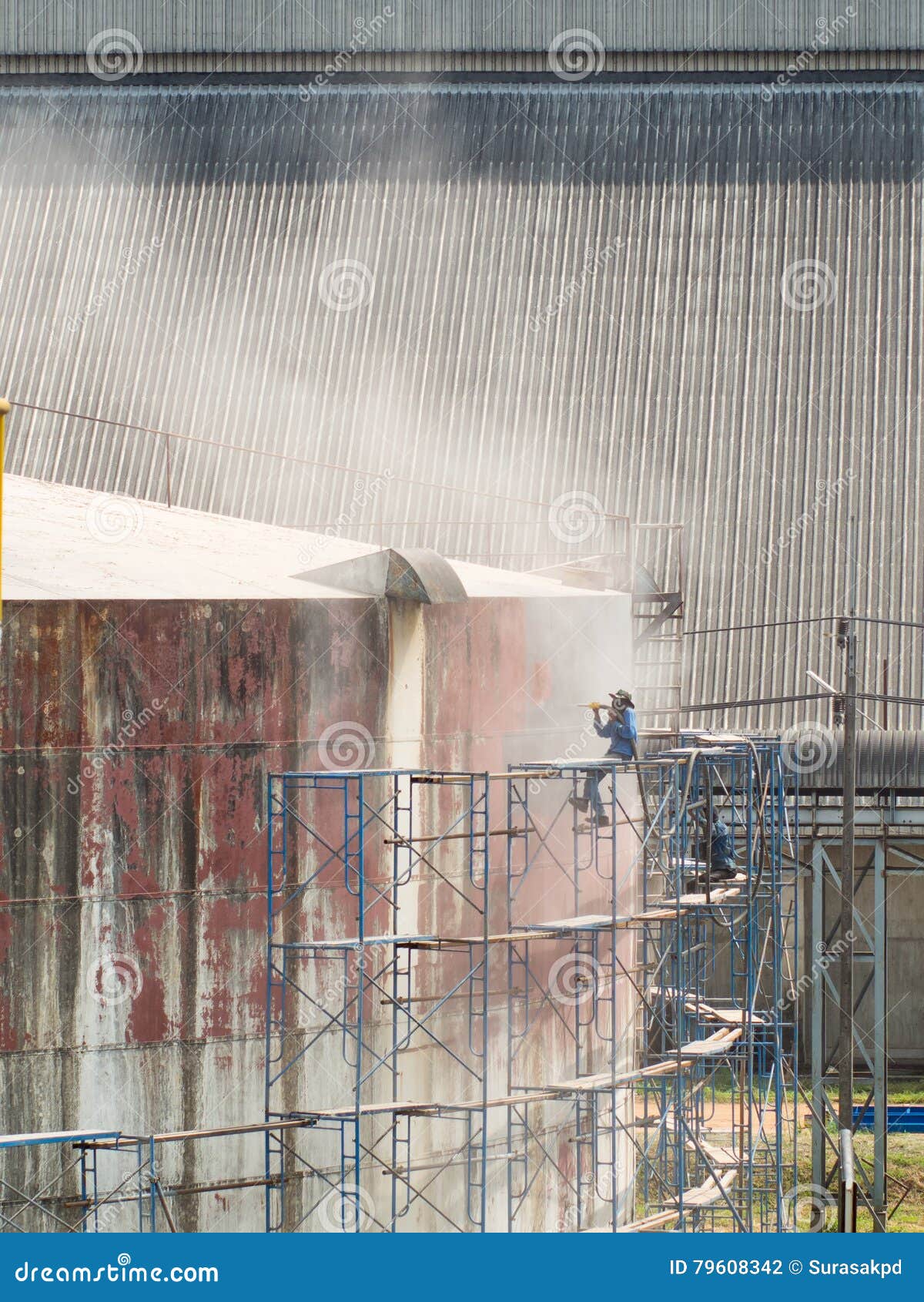 Worker Cleaning Storage Tank by Air Pressure Sand Blasting. Stock Photo ...