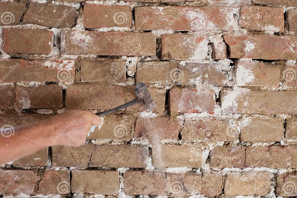 A Worker Cleans an Old Brick Wall with a Chisel. Renovation of an Old ...