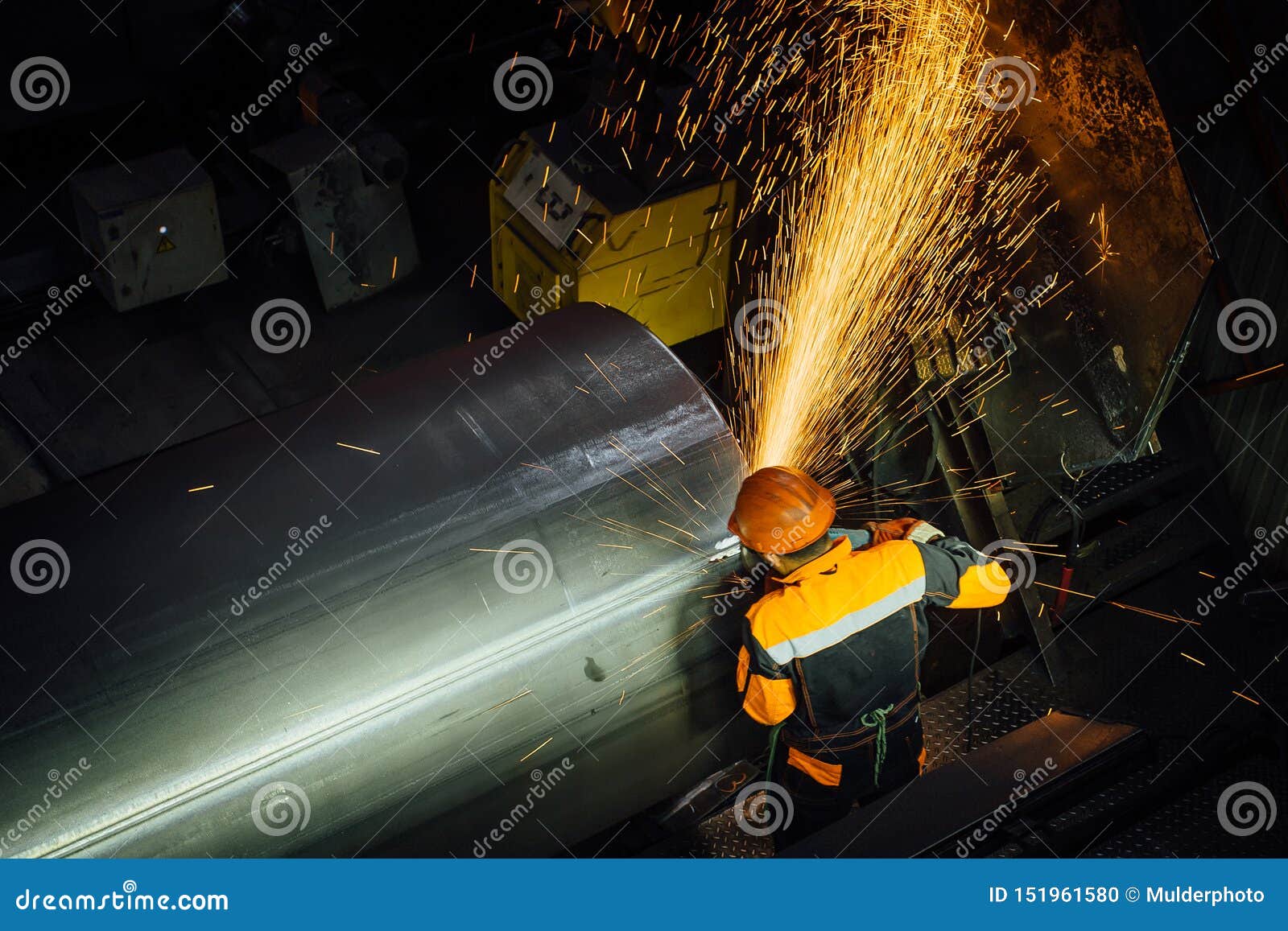 Worker Cleans Welded Seam on Steel Pipe Using Grinding Machine in ...