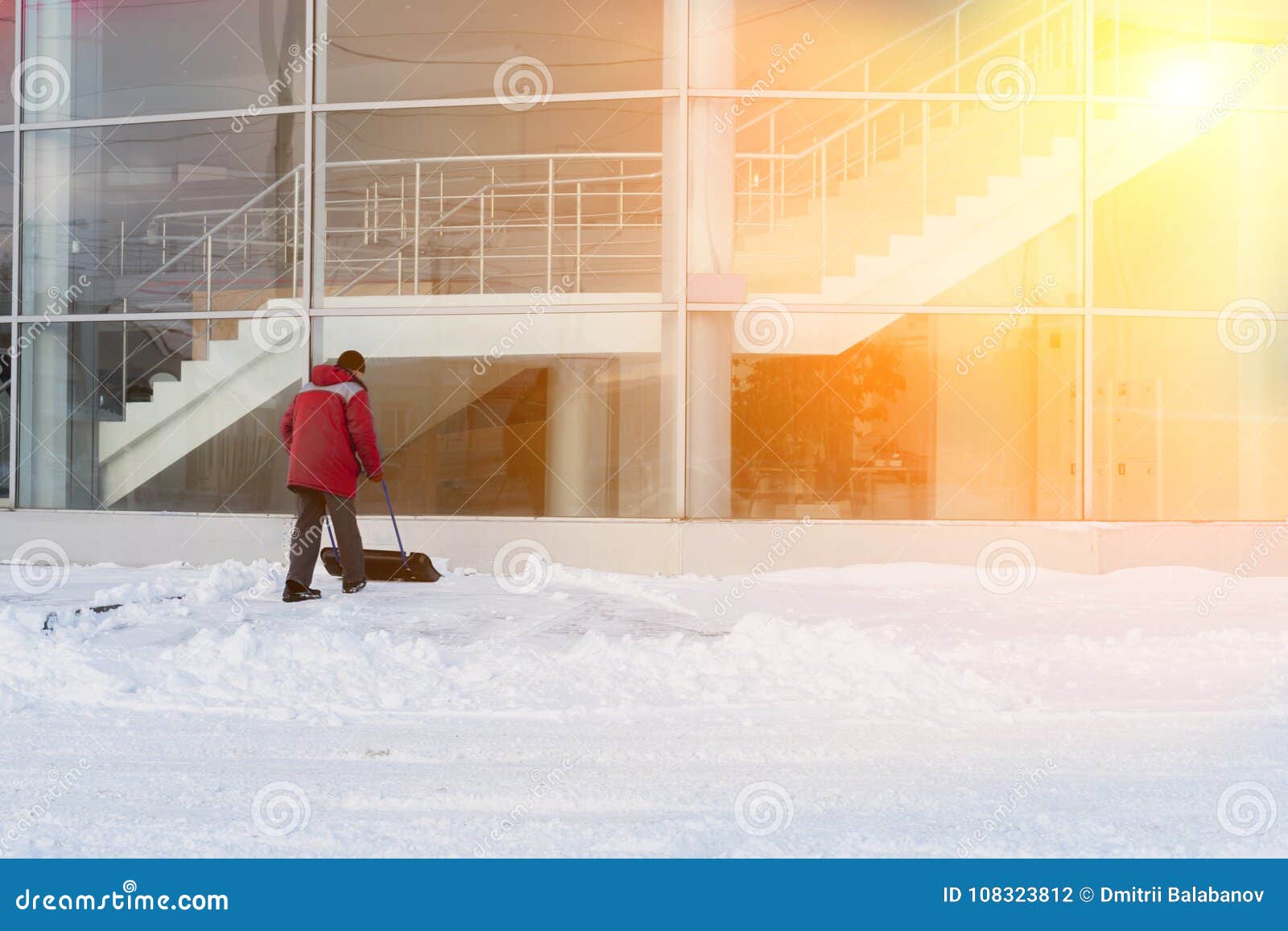 A Worker Clears Snow after a Snowstorm in Front of a Large Office ...