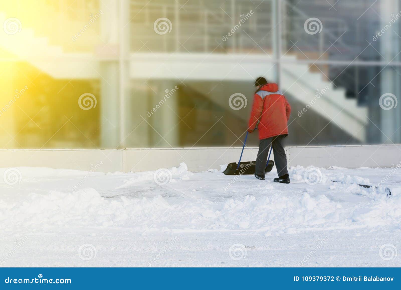A Worker Clears Snow after a Snowstorm in Front of a Large Office ...