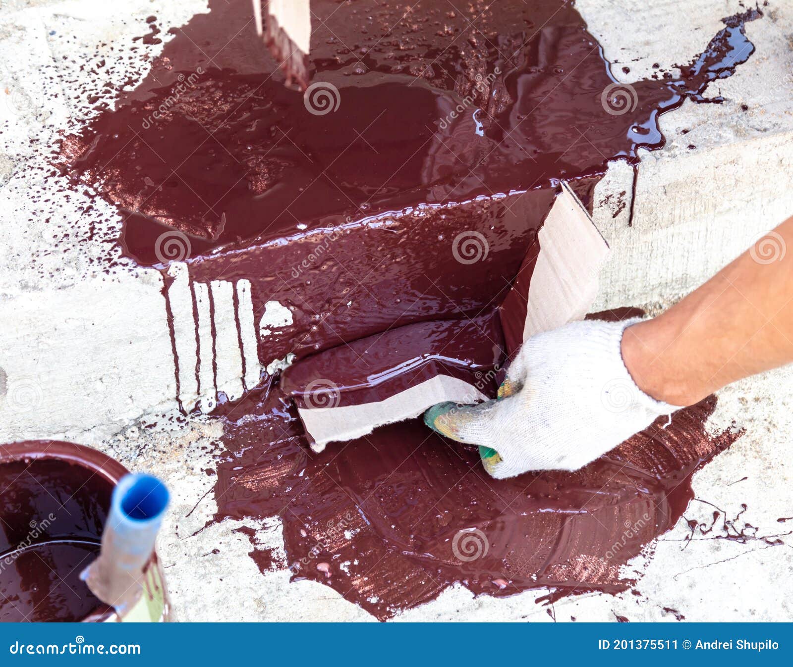 A Worker Collects Paint Spilled on Concrete Stock Image - Image of hand ...