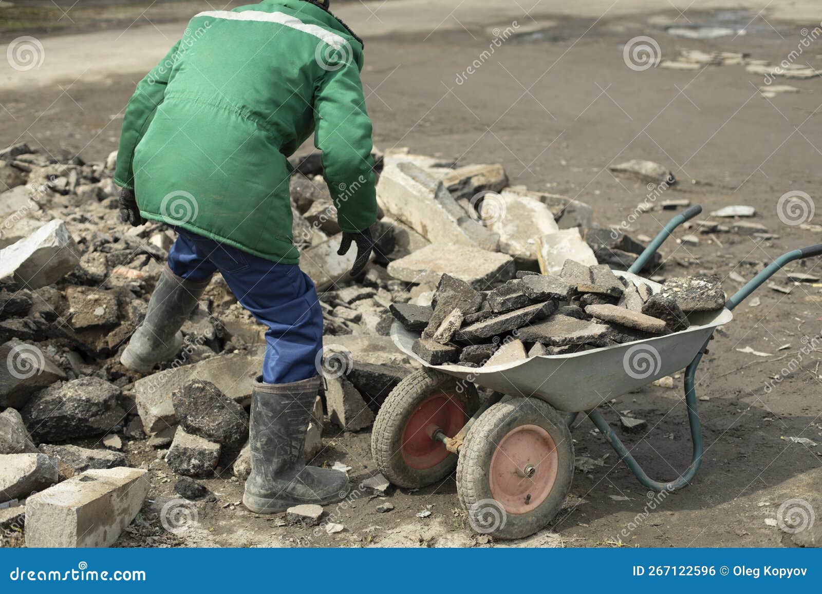 Worker Collects Stones in Cart. Construction Debris in Garden Cart ...