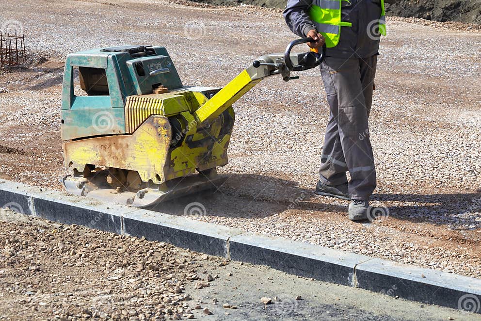 Worker Compacting Soil Using Compactor in a City Park Stock Image ...