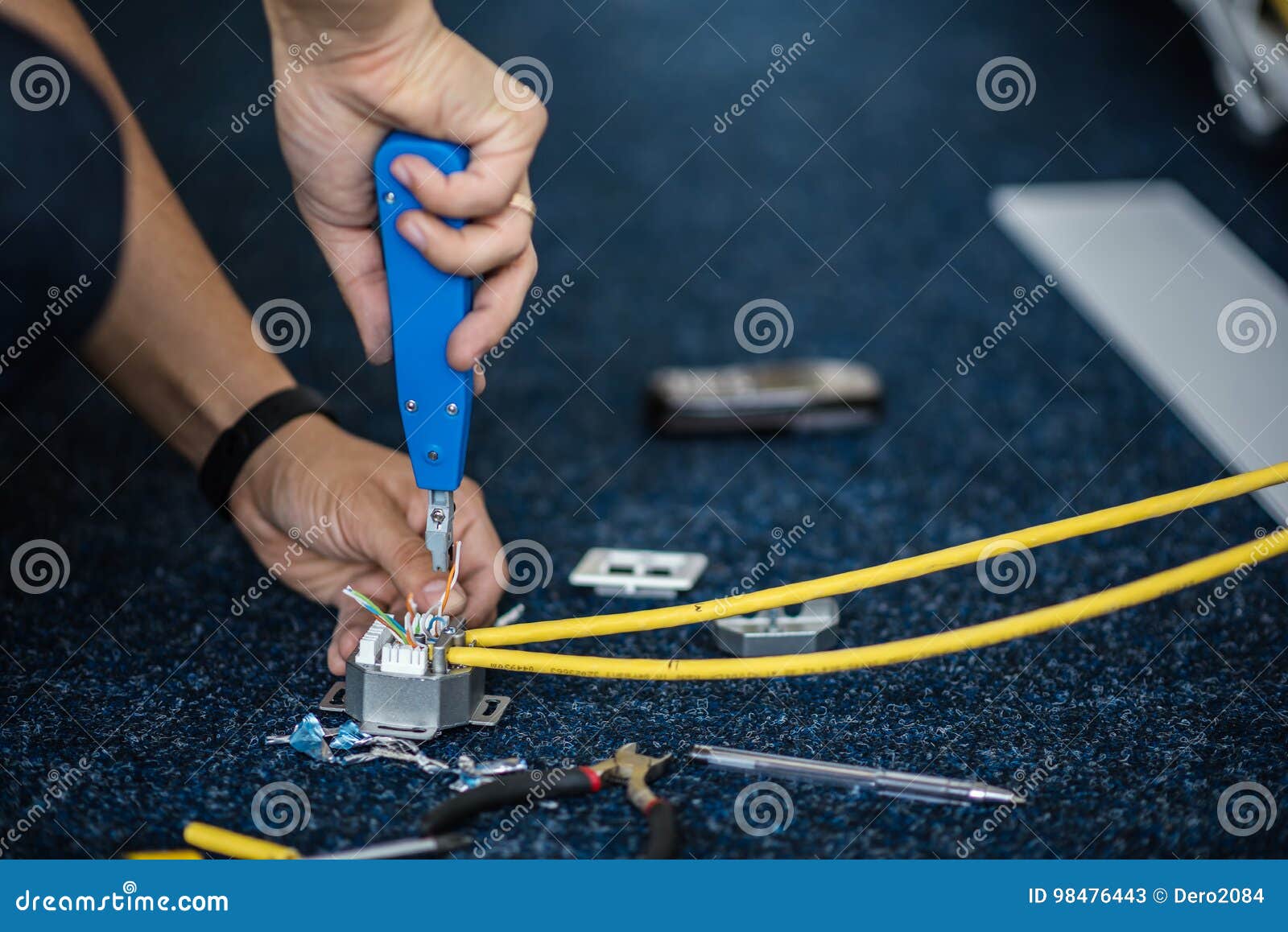 Worker Connect a Network Cable with RJ45 Sockets by Punch-down Tool ...