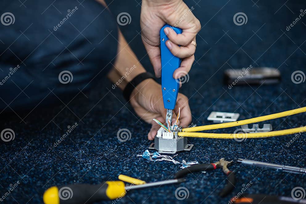 Worker Connect a Network Cable with RJ45 Sockets by Punch-down Tool ...