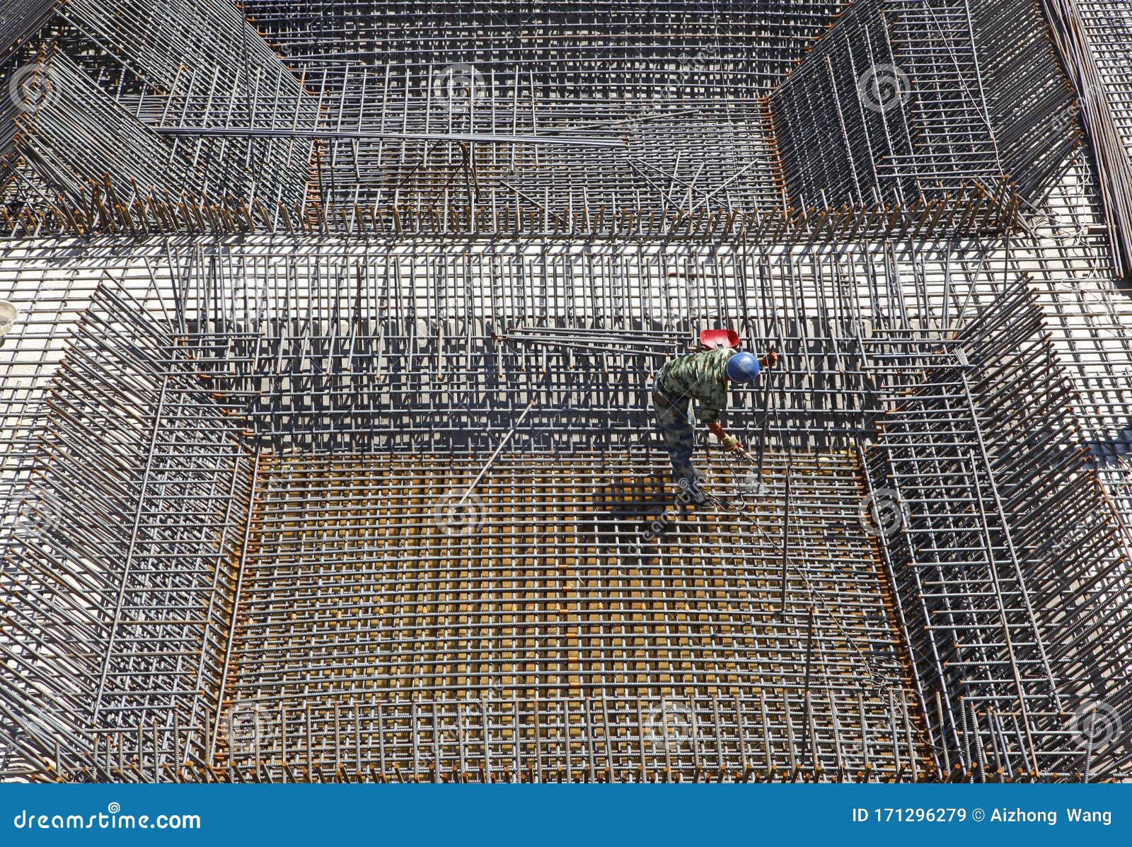 Worker in the Construction Site Making Reinforcement Metal Framework ...