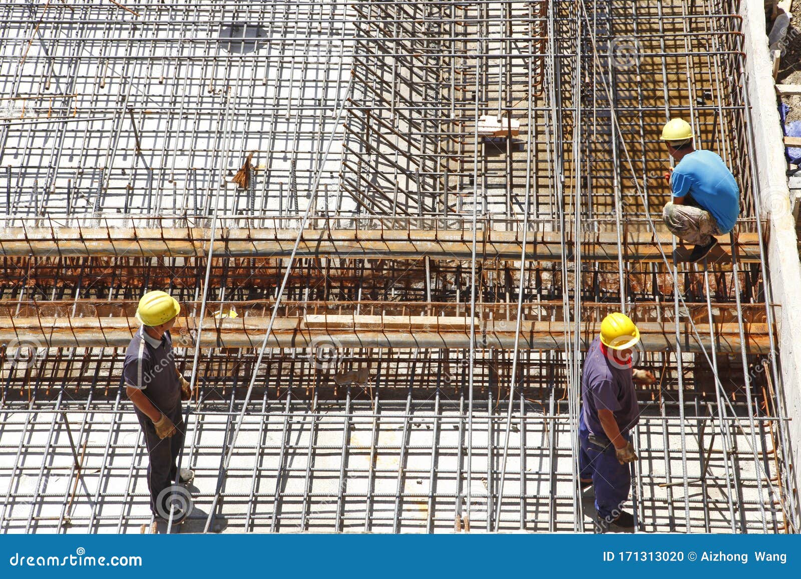 Worker in the Construction Site Making Reinforcement Metal Framework ...