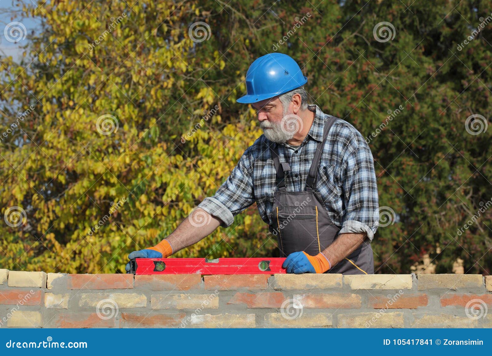 Worker Examining Brick Wall Stock Image - Image of home, leveler: 105417841