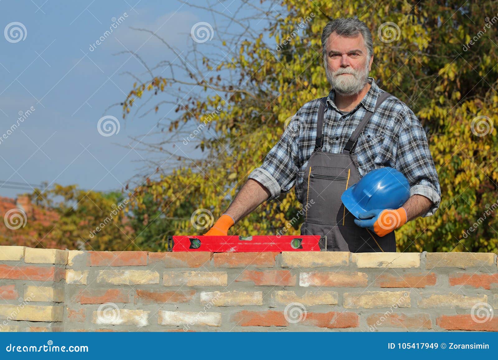 Worker Examining Brick Wall at Construction Site Stock Image - Image of ...