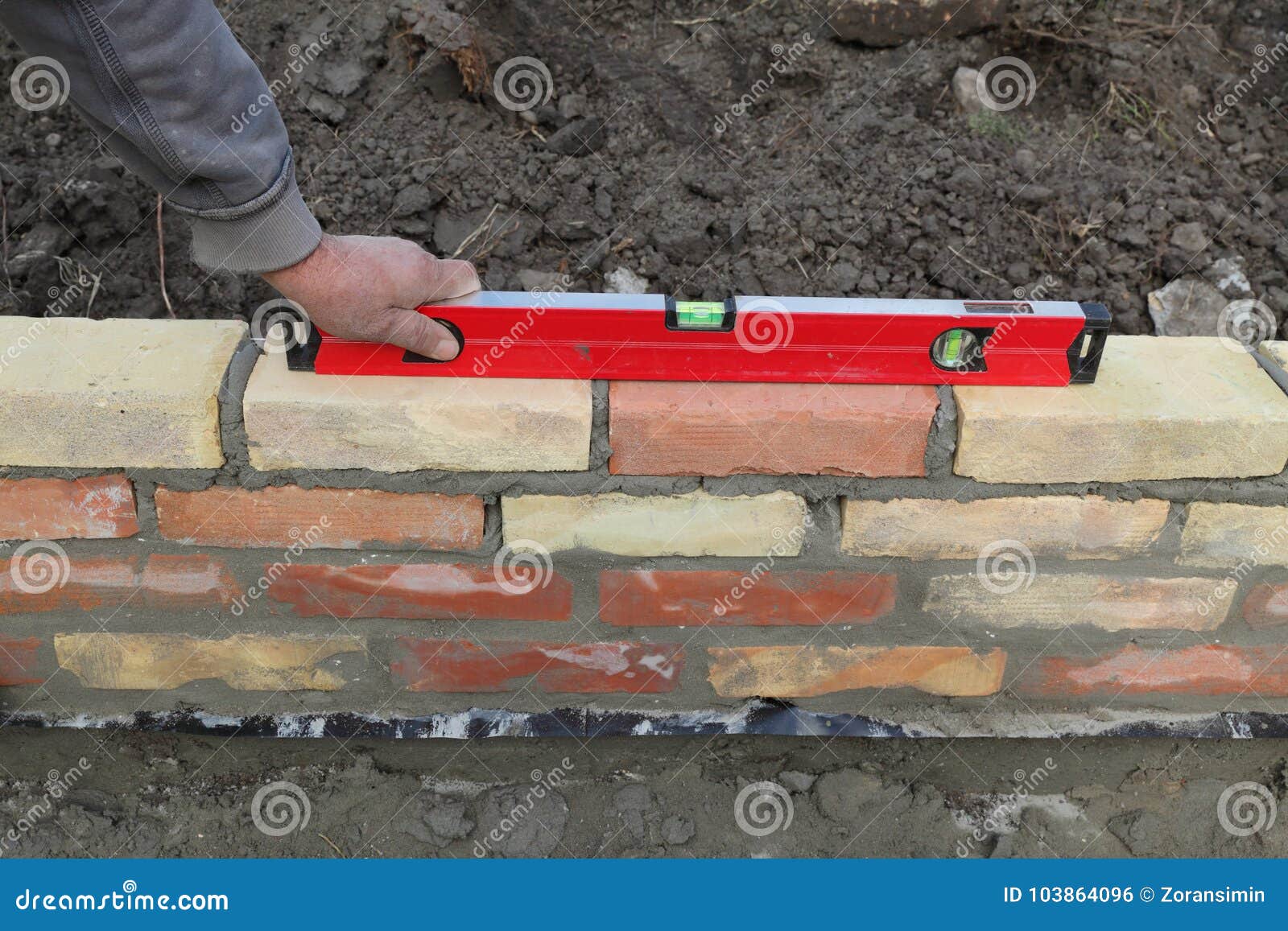 Worker building brick wall stock photo. Image of bricklayer - 103864096