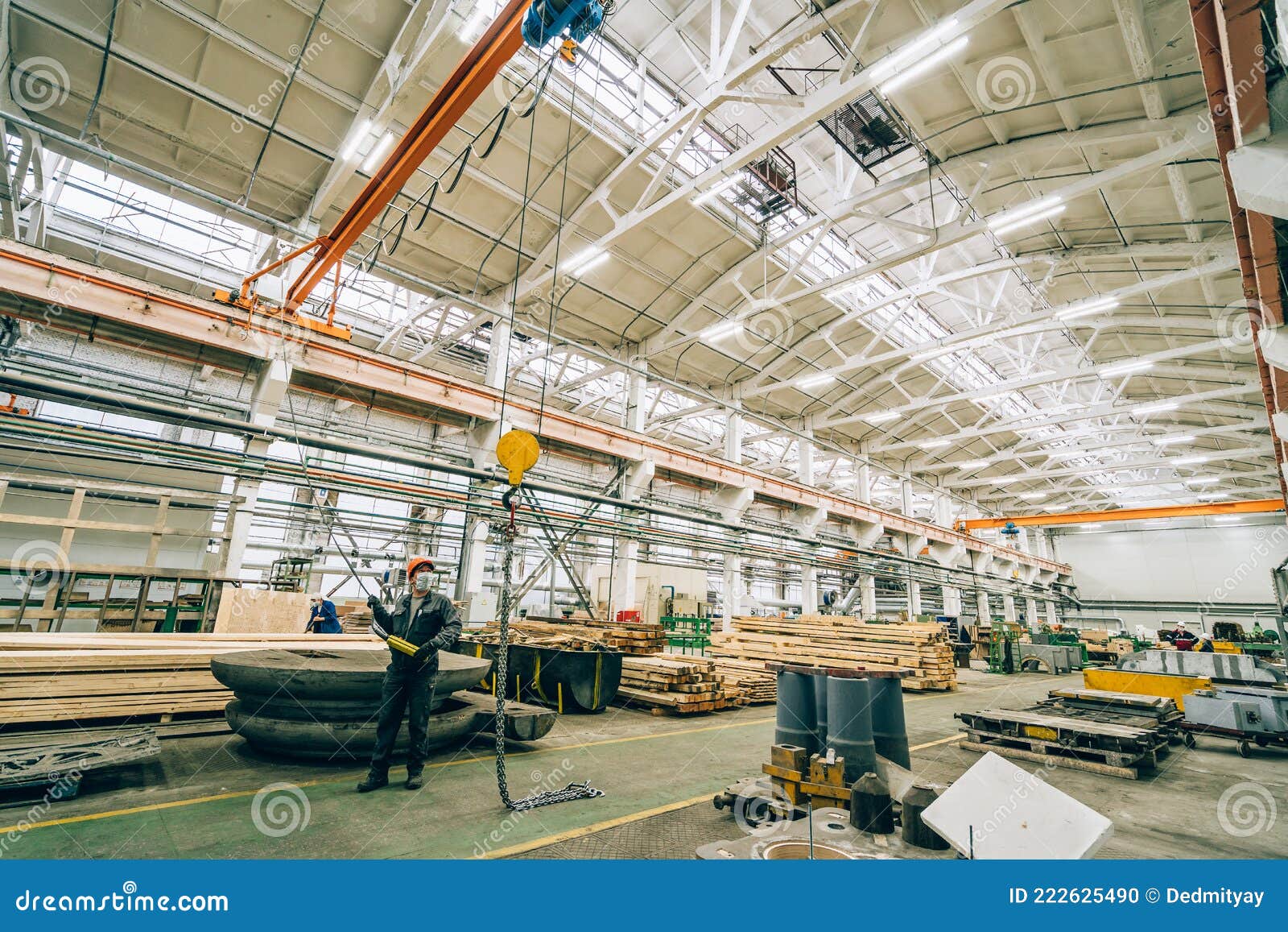 Worker Controls Girder Crane with Remote Control in Woodworking ...