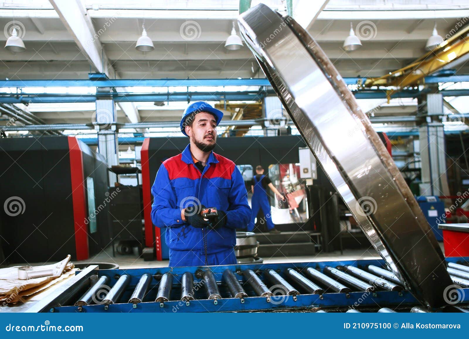 A Worker Controls the Transportation of a Large Diameter Bearing. the ...
