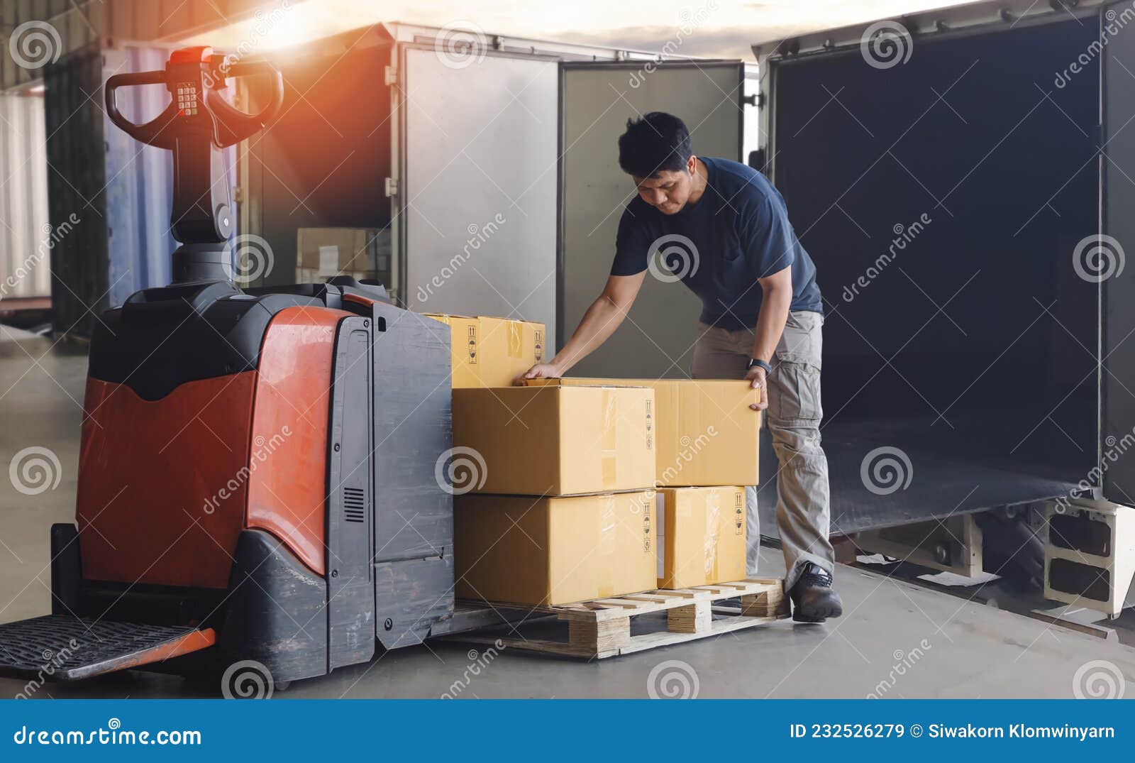 Worker Courier Lifting Package Boxes Stack on Pallet. Cargo Loading at ...