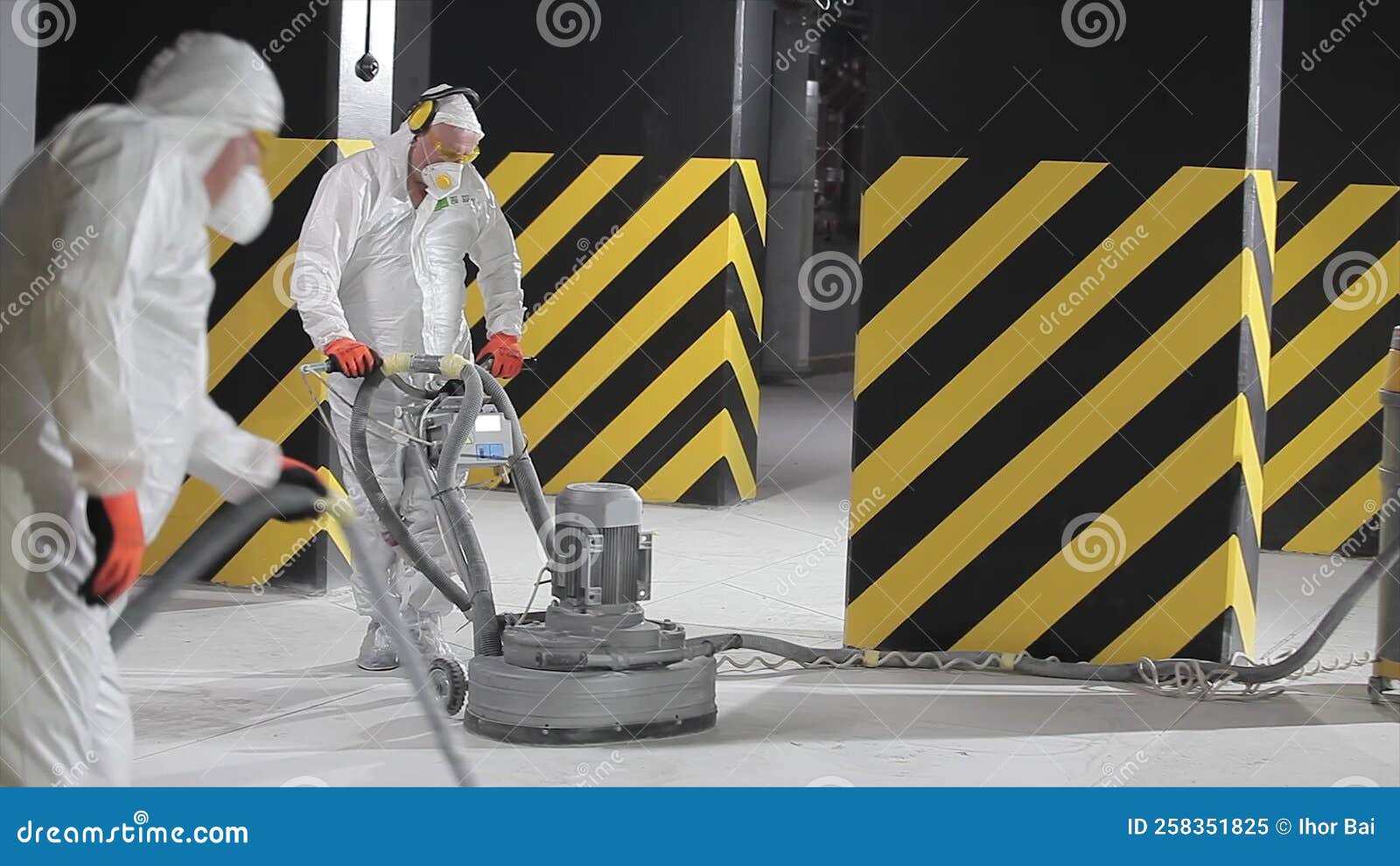 A Worker Creates a Level Concrete Floor. Concrete Floor Grinding ...