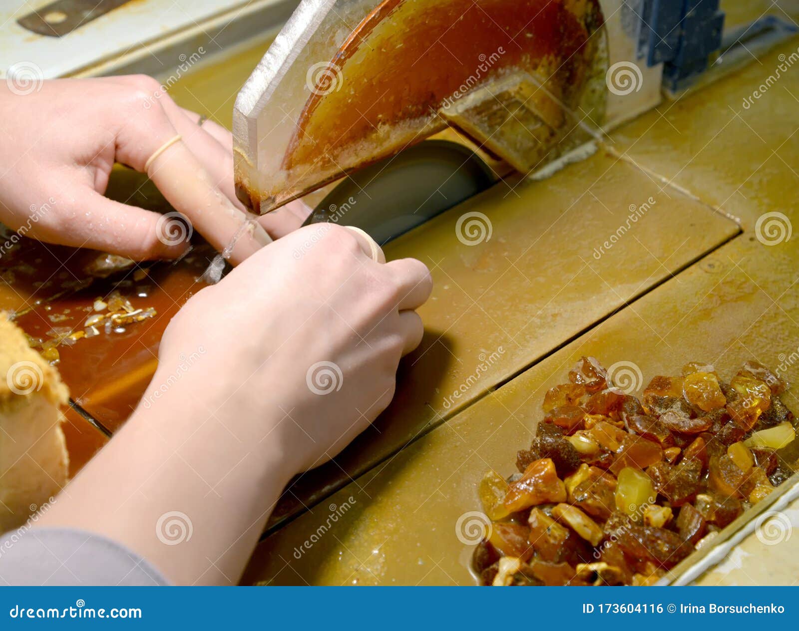 The Worker Cuts Amber Stones with a Disk Table Saw. Amber Processing ...