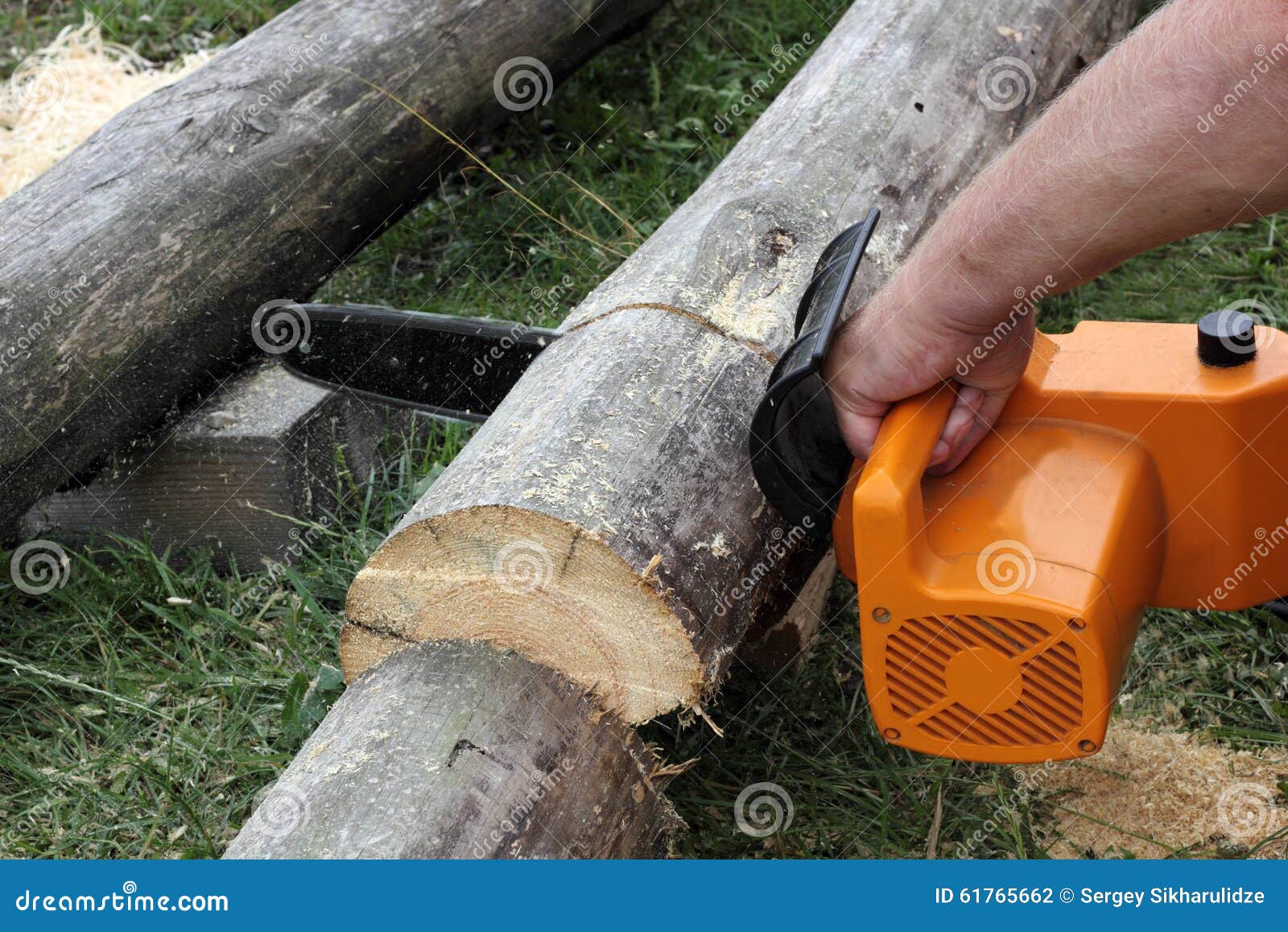 Worker Cuts a Beam by Electric Chain Saw Stock Photo - Image of hands ...