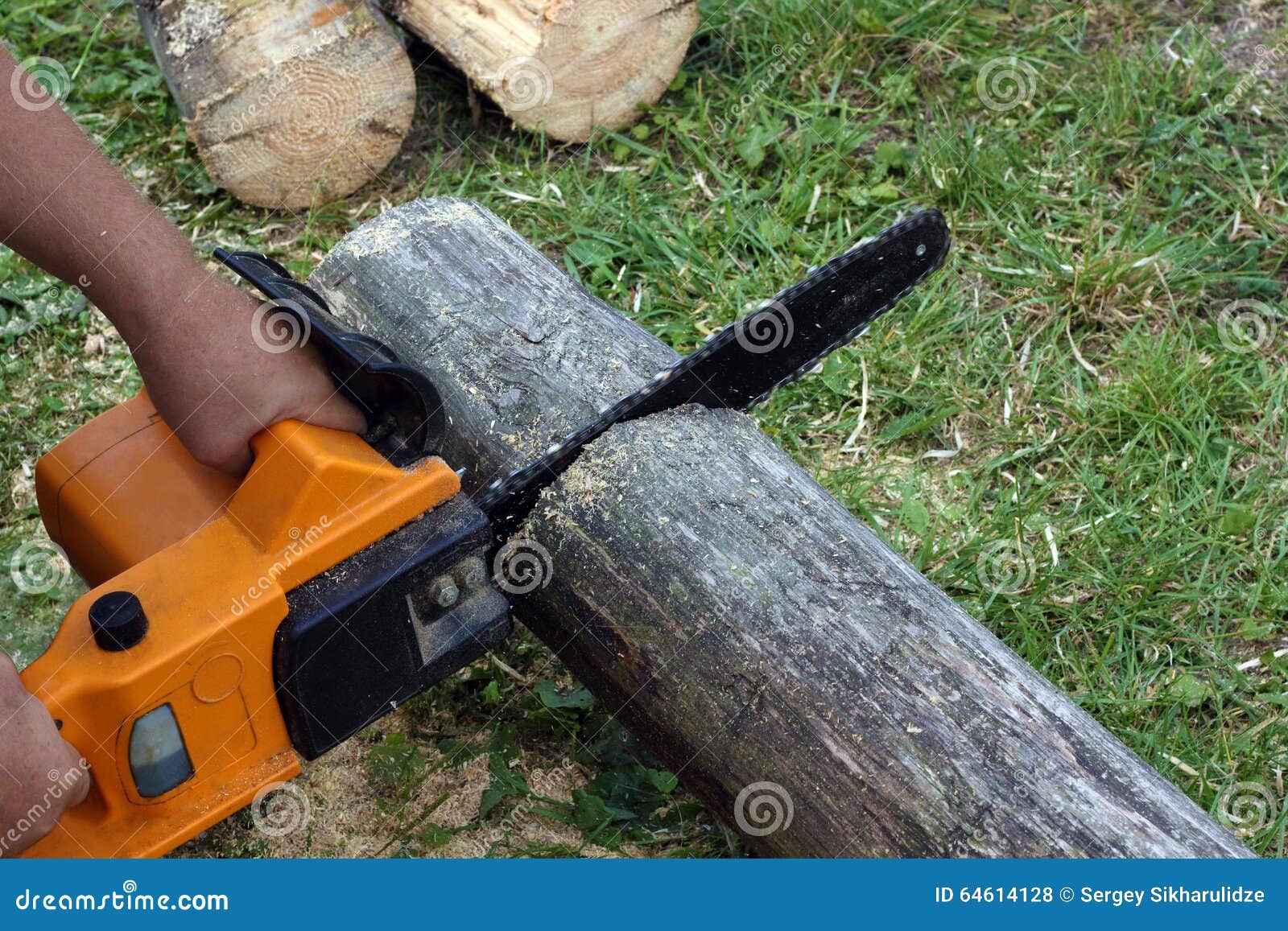 Worker Cuts a Beam by Electric Chain Saw Stock Photo - Image of work ...