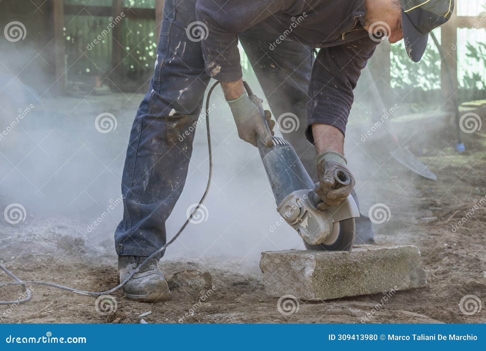 A Worker Cuts a Concrete Block with an Electric Angle Grinder Stock ...