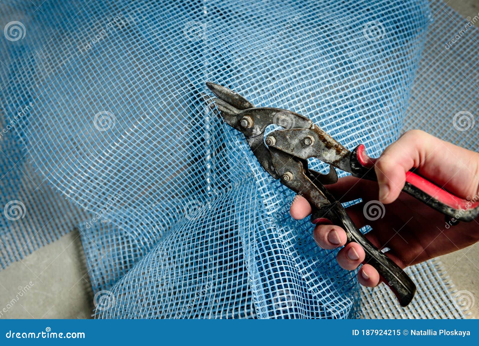 Worker Cuts a Facade Grid at a Construction Site Stock Image - Image of ...