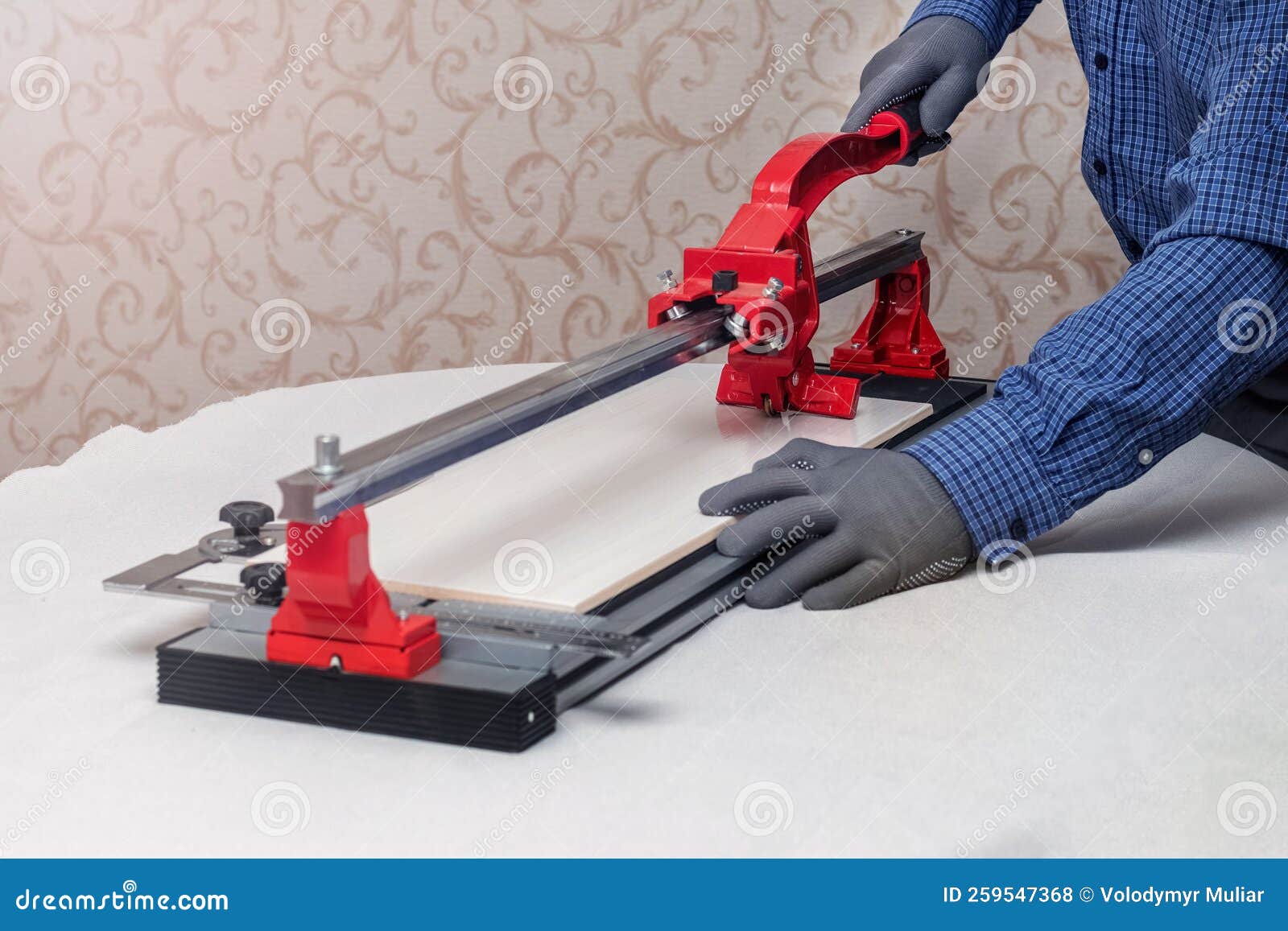 A Worker Cuts Facing Tiles with a Tile Cutter Stock Photo - Image of ...