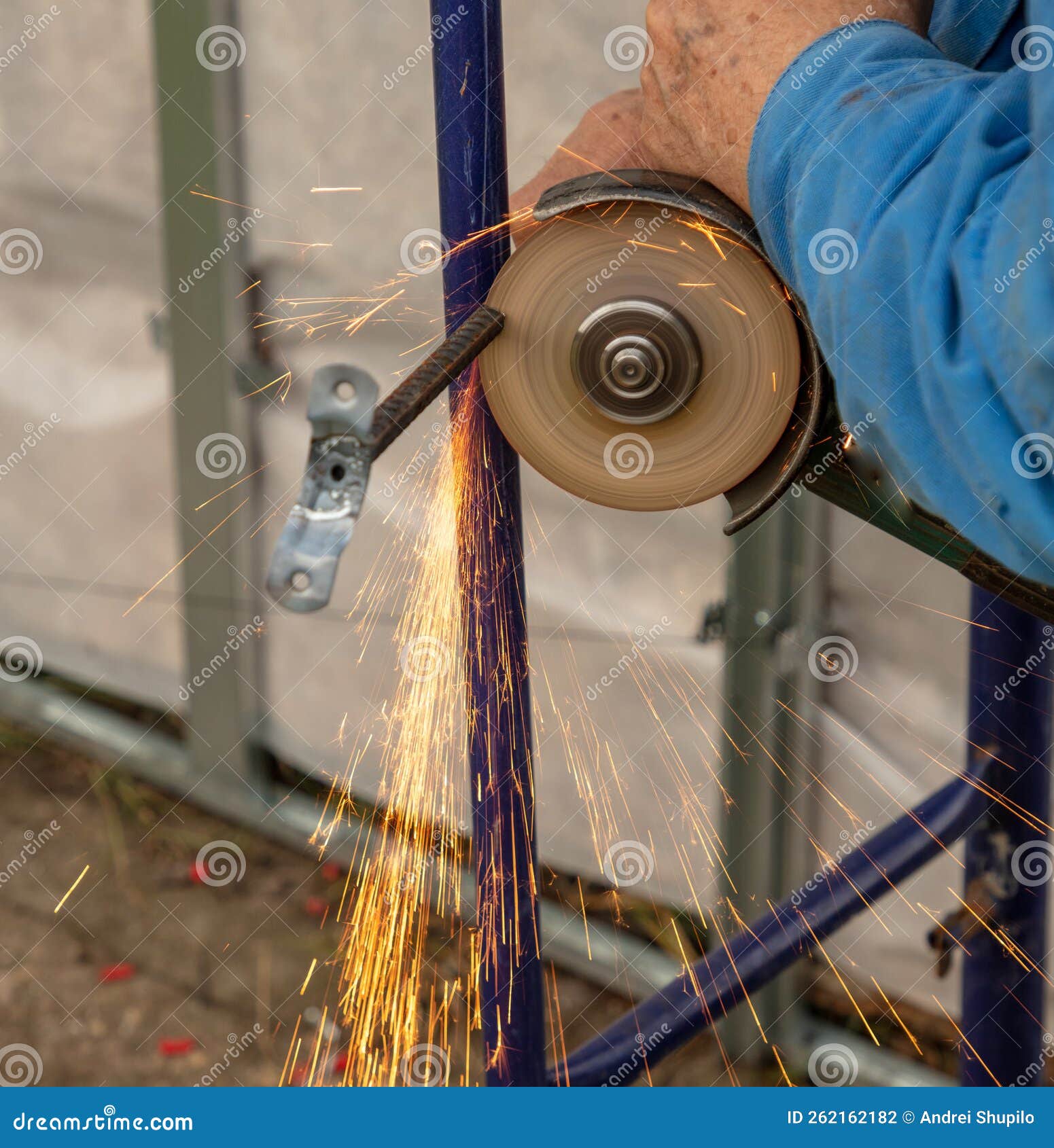 A Worker Cuts Metal at a Construction Site Stock Photo - Image of work ...