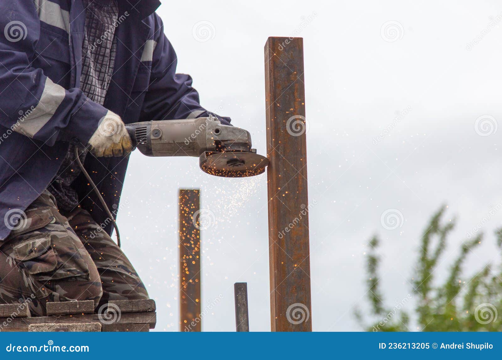 A Worker Cuts Metal at a Construction Site. Technologies Stock Image ...