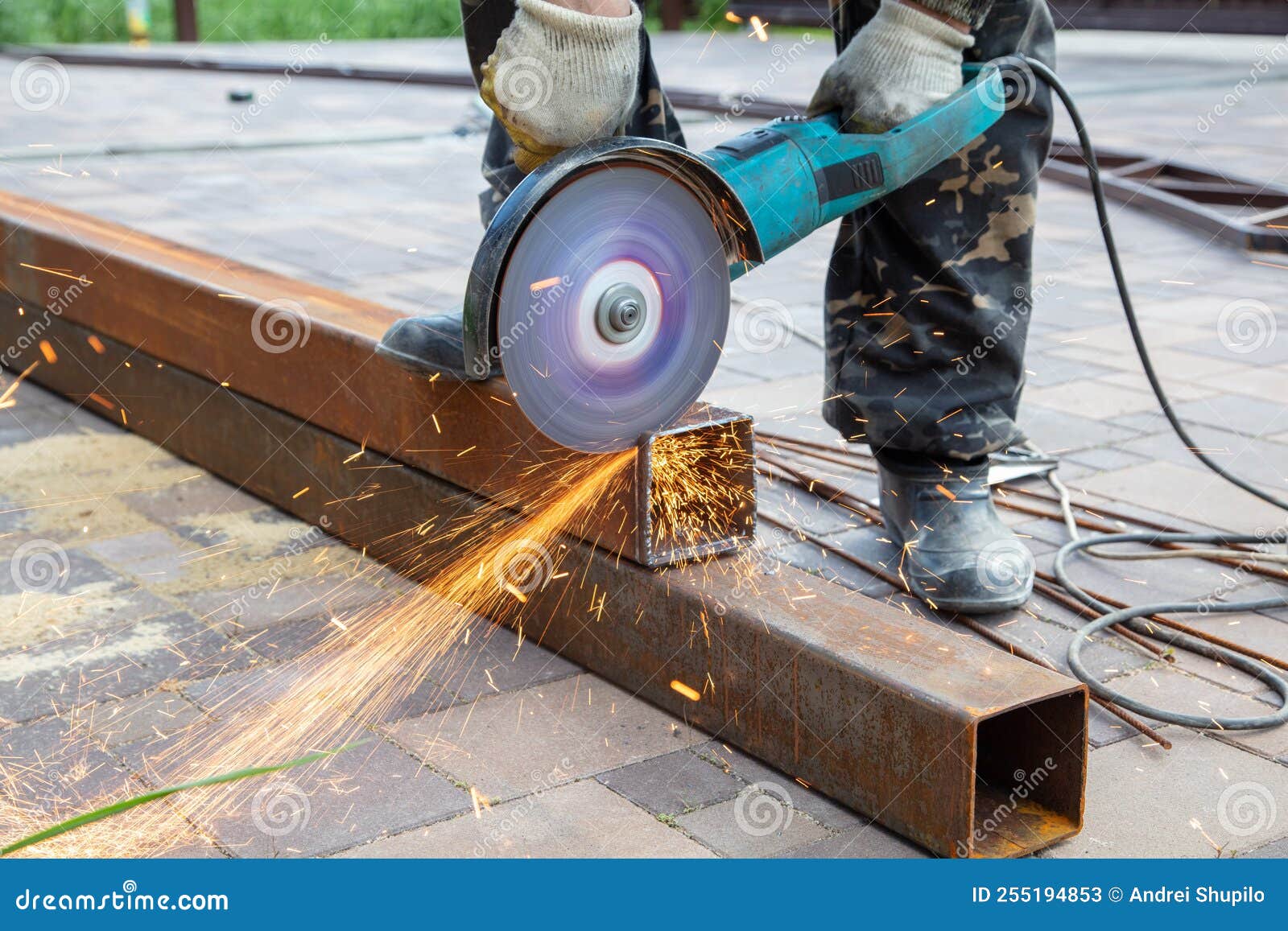 A Worker Cuts Metal at a Construction Site. Stock Image - Image of ...