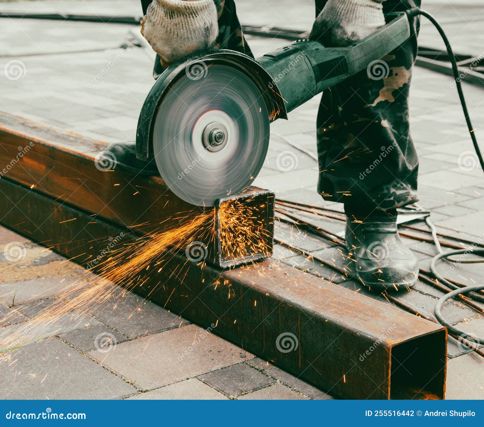 A Worker Cuts Metal at a Construction Site. Stock Photo - Image of work ...