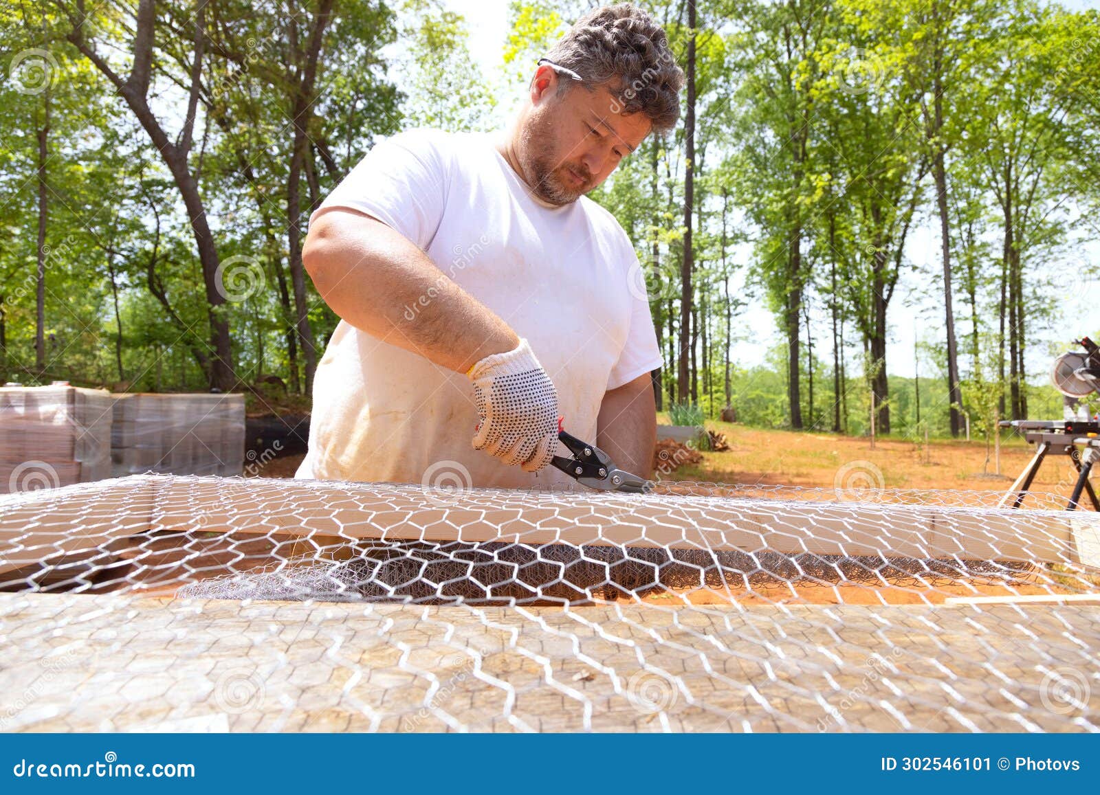 A Worker Cuts Metal Mesh Using Scissors for Metal Stock Image - Image ...