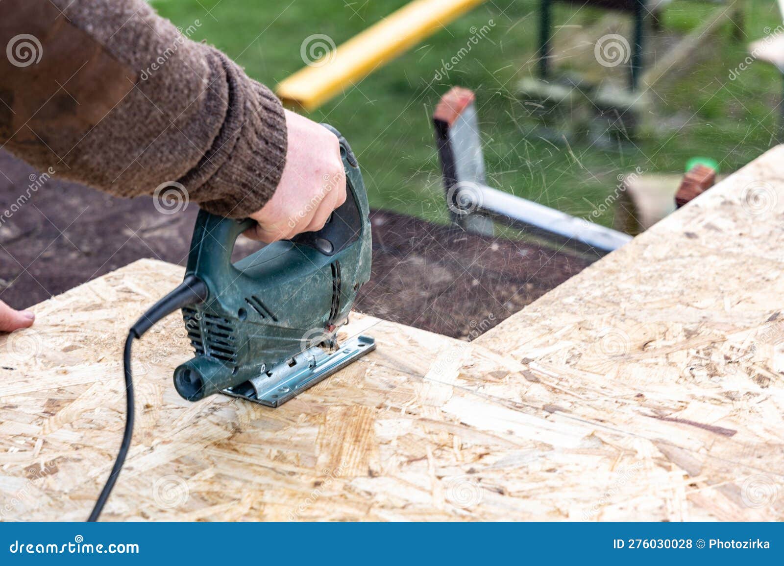 Worker Cuts an OSB Sheet with Electric Jigsaw Stock Photo - Image of ...