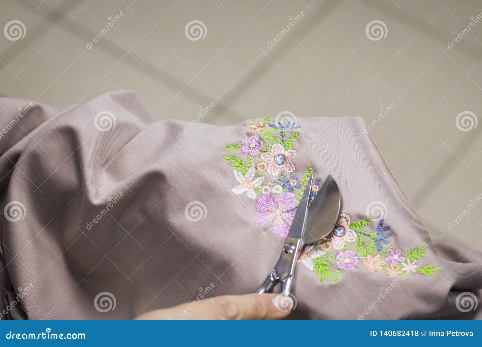 The Worker Cuts the Short Loose Ends of the Threads from the Garment ...