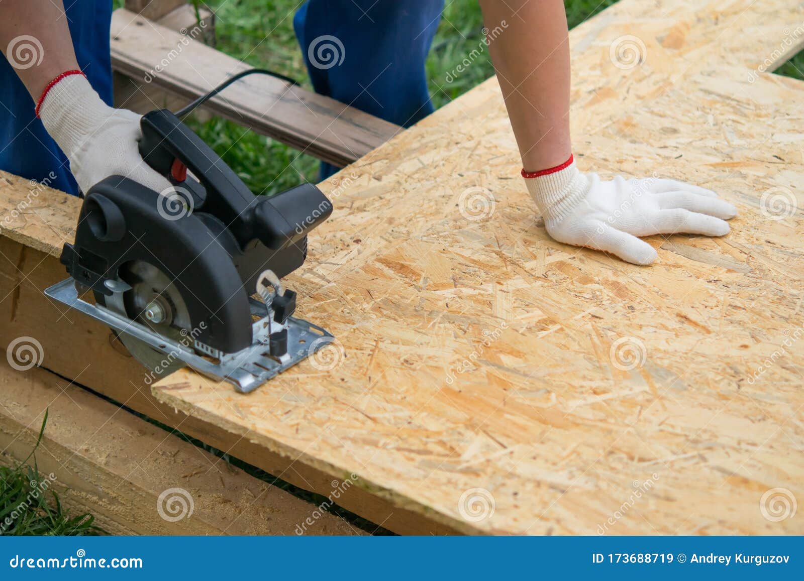 A Worker Cuts a Wooden Board with an Electric Saw Stock Image - Image ...