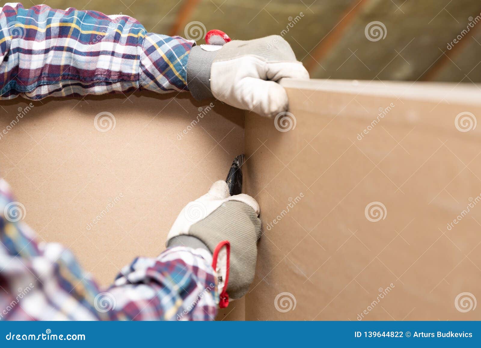 Worker Cutting Drywall Plasterboard with Construction Knife. Attic ...