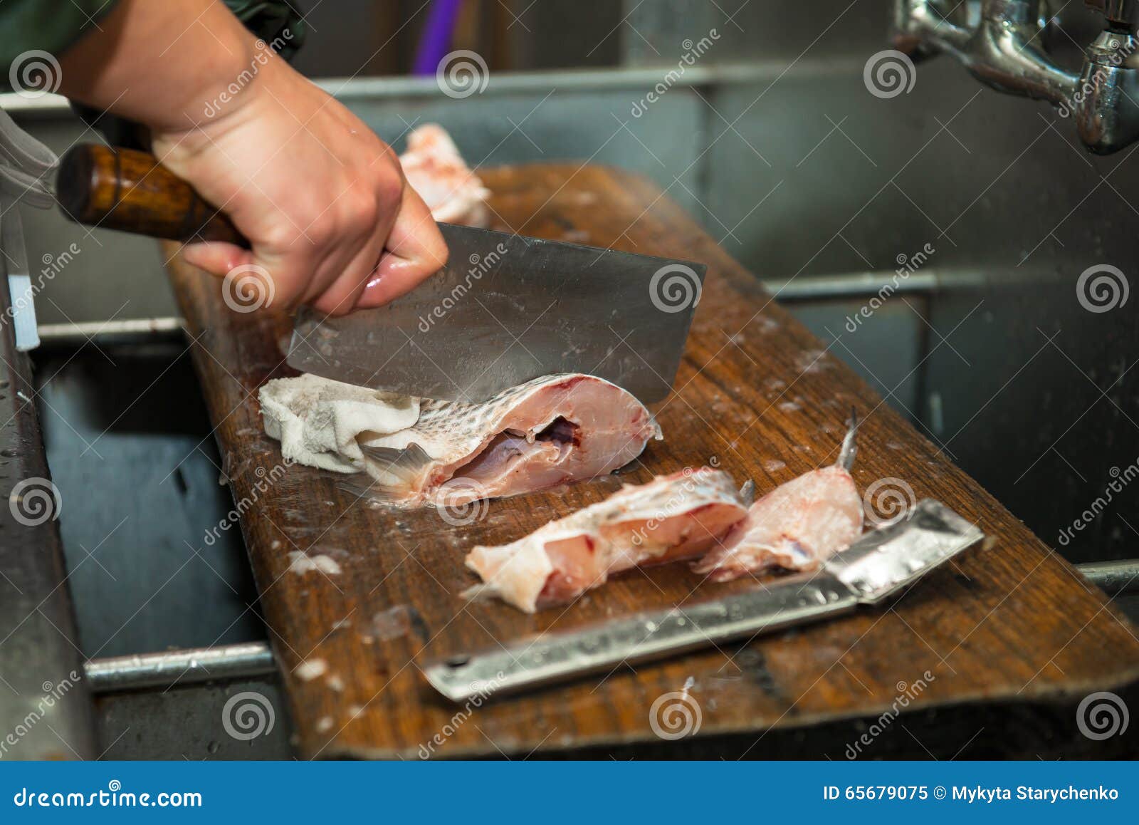 Worker Cutting Fish on a Board at the Restaurant Kitchen Stock Image ...