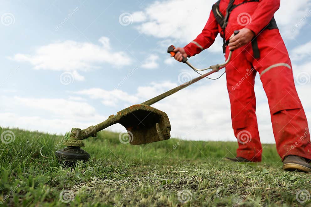 Worker Cutting Grass with String Trimmer Outdoors, Closeup View Stock ...