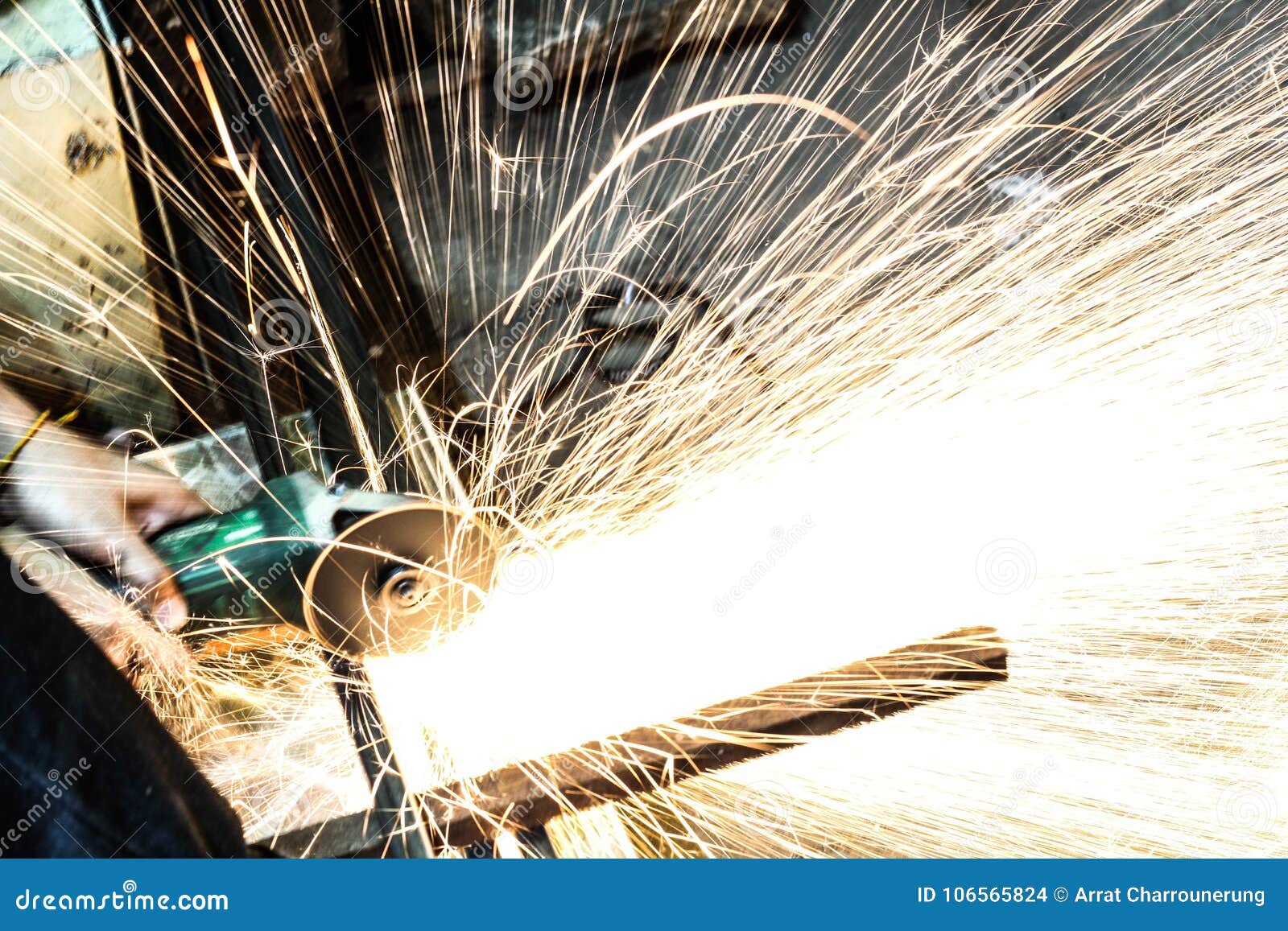 Worker Cutting Metal with Grinder. Sparks while Grinding Iron Stock ...