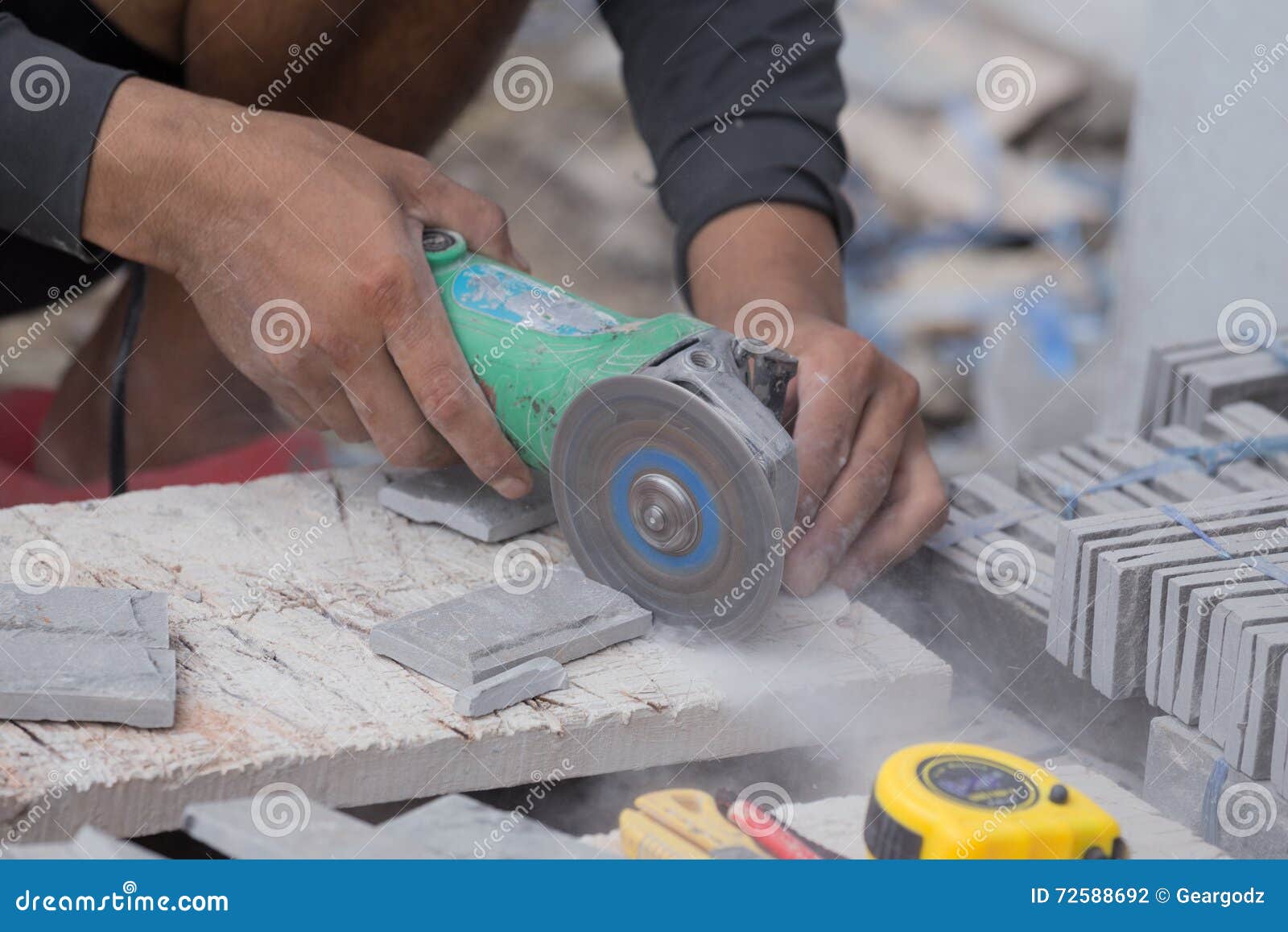 Worker Cutting a Sand Stone Tile Using an Angle Grinder Stock Photo ...