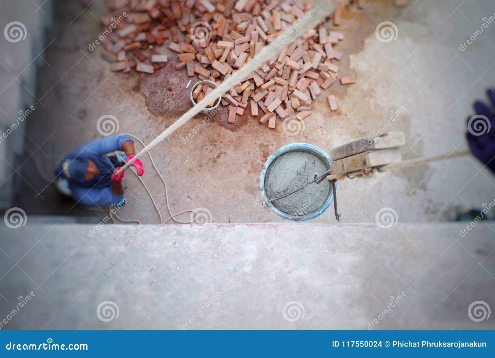 Worker Delivers the Materials by Using Hoist at the Construction Site ...