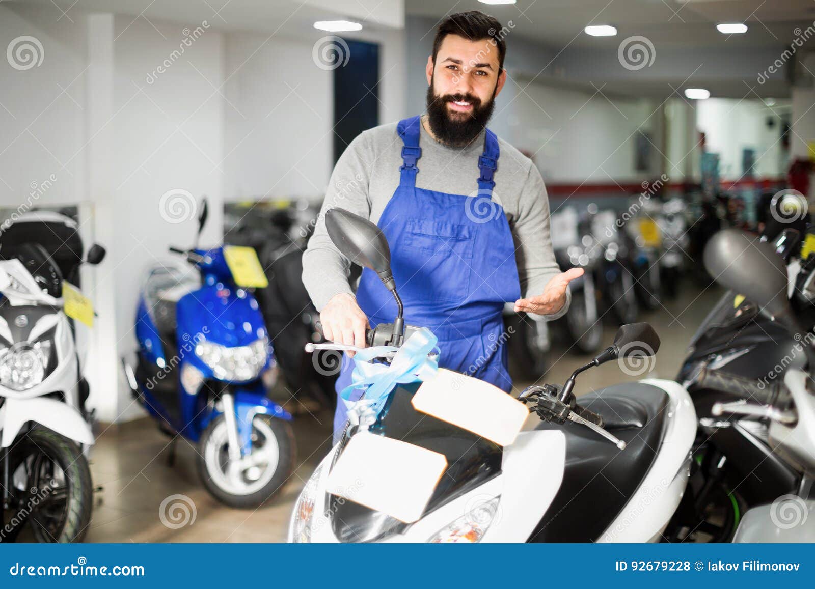 Worker Demonstrating Motorcycles and Scooters Stock Photo - Image of ...